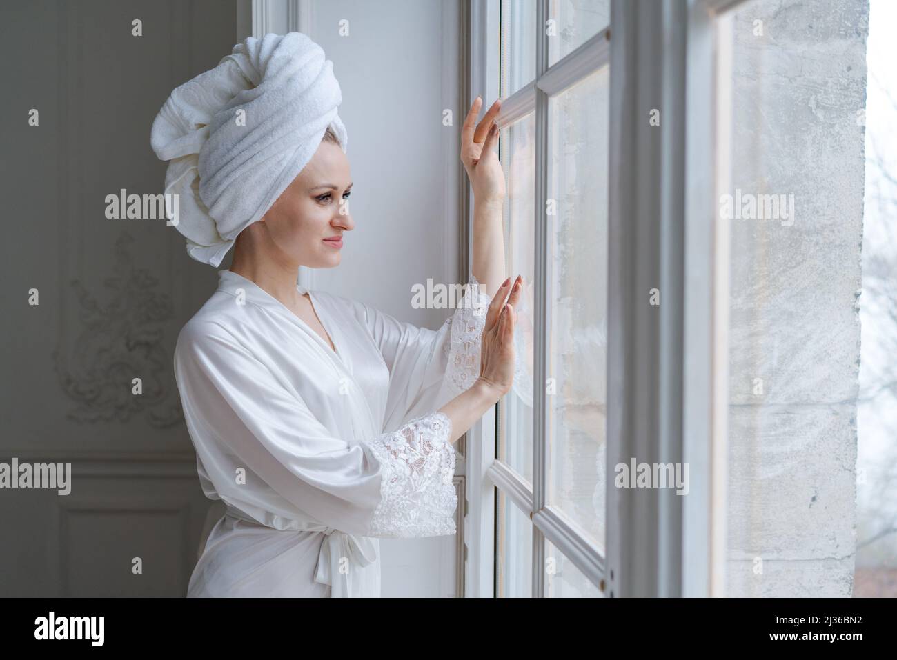 Portrait gorgeous young woman wearing white silk robe and turban towel ...