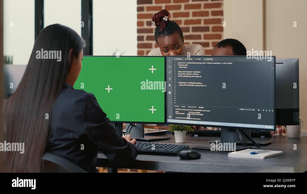 Software Developer Writing Algorithm In Front Of Computer With Green Screen Chroma Key Mockup In