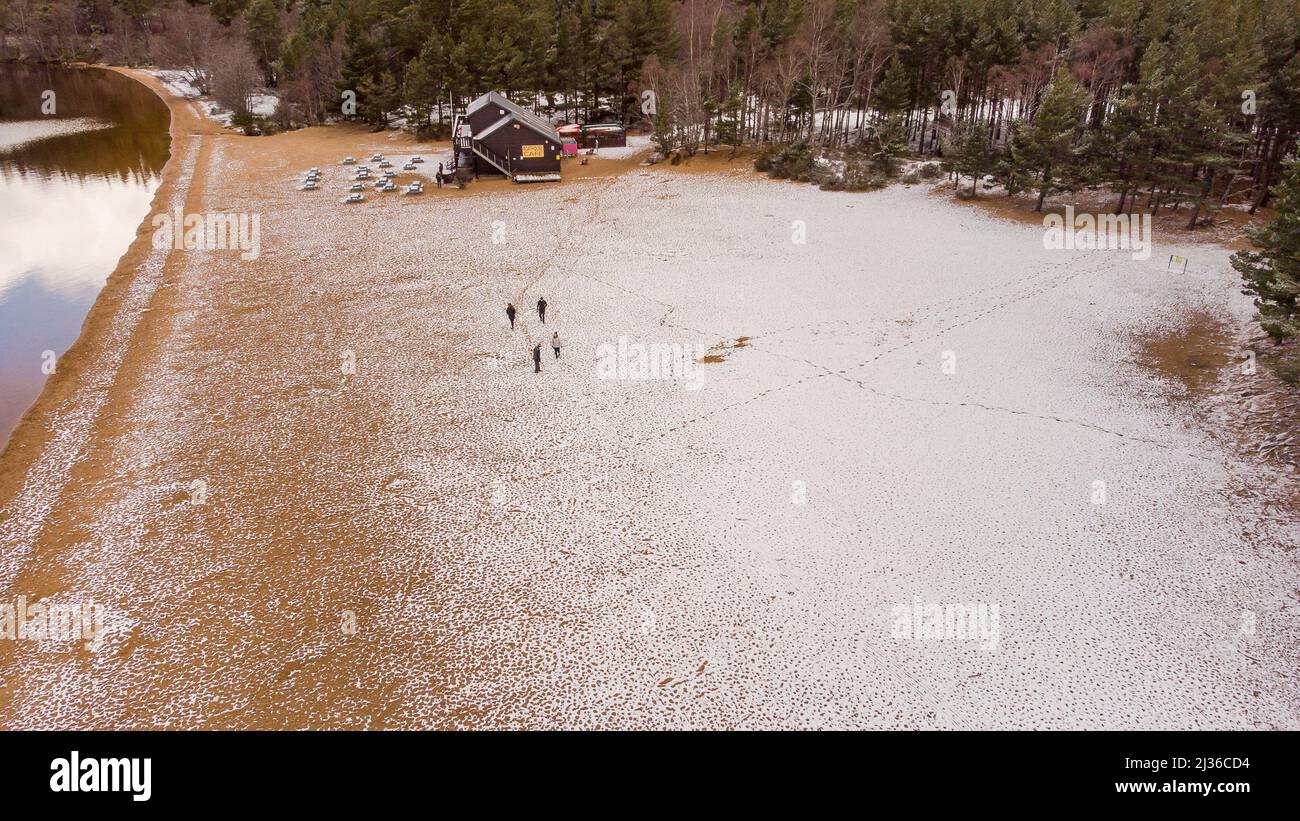 Loch Morlich beach in the Scottish highlands is snowfell, in aerial ...