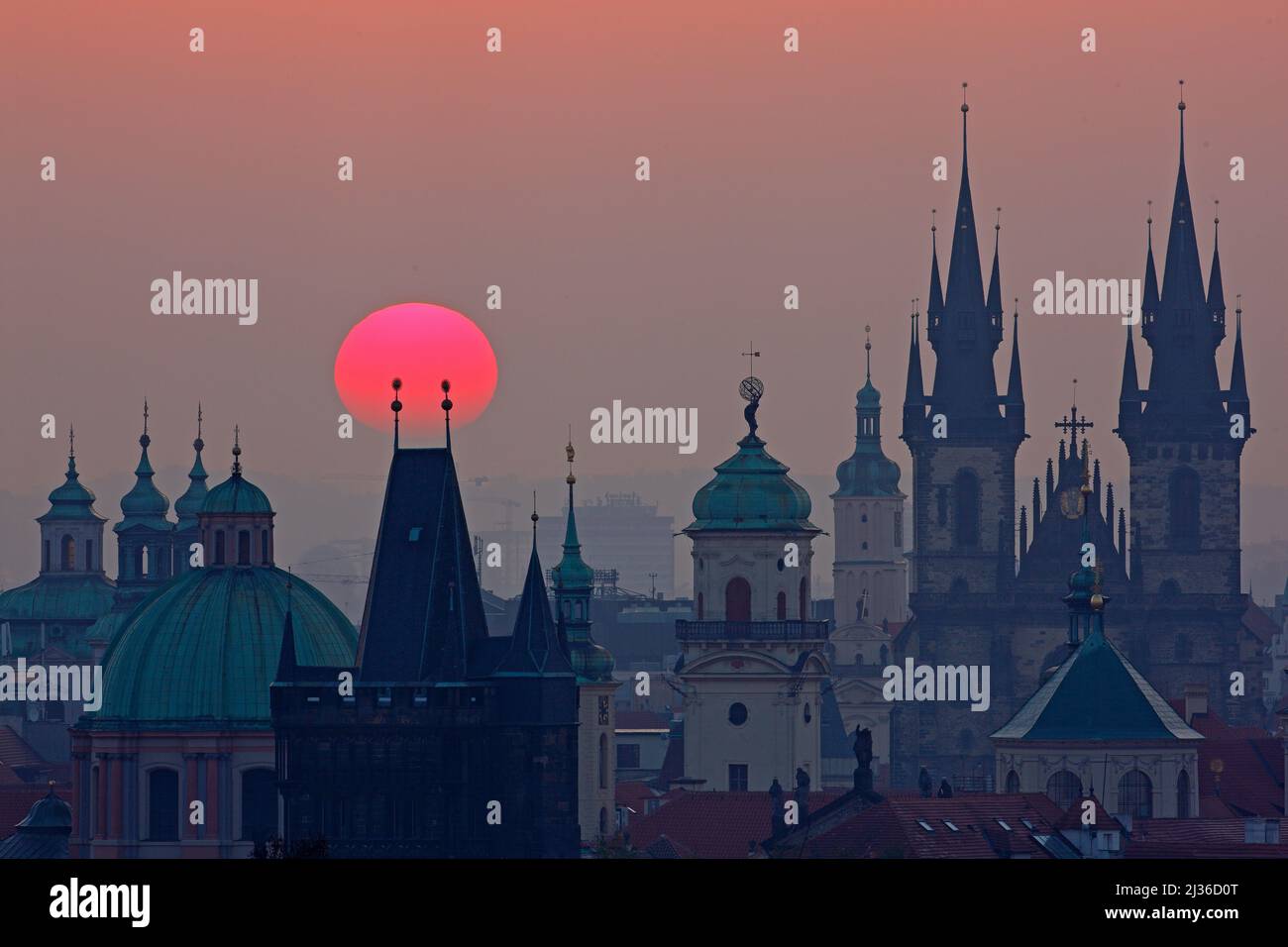 Twilight in historical city. Magical picture of tower with orange sun ...