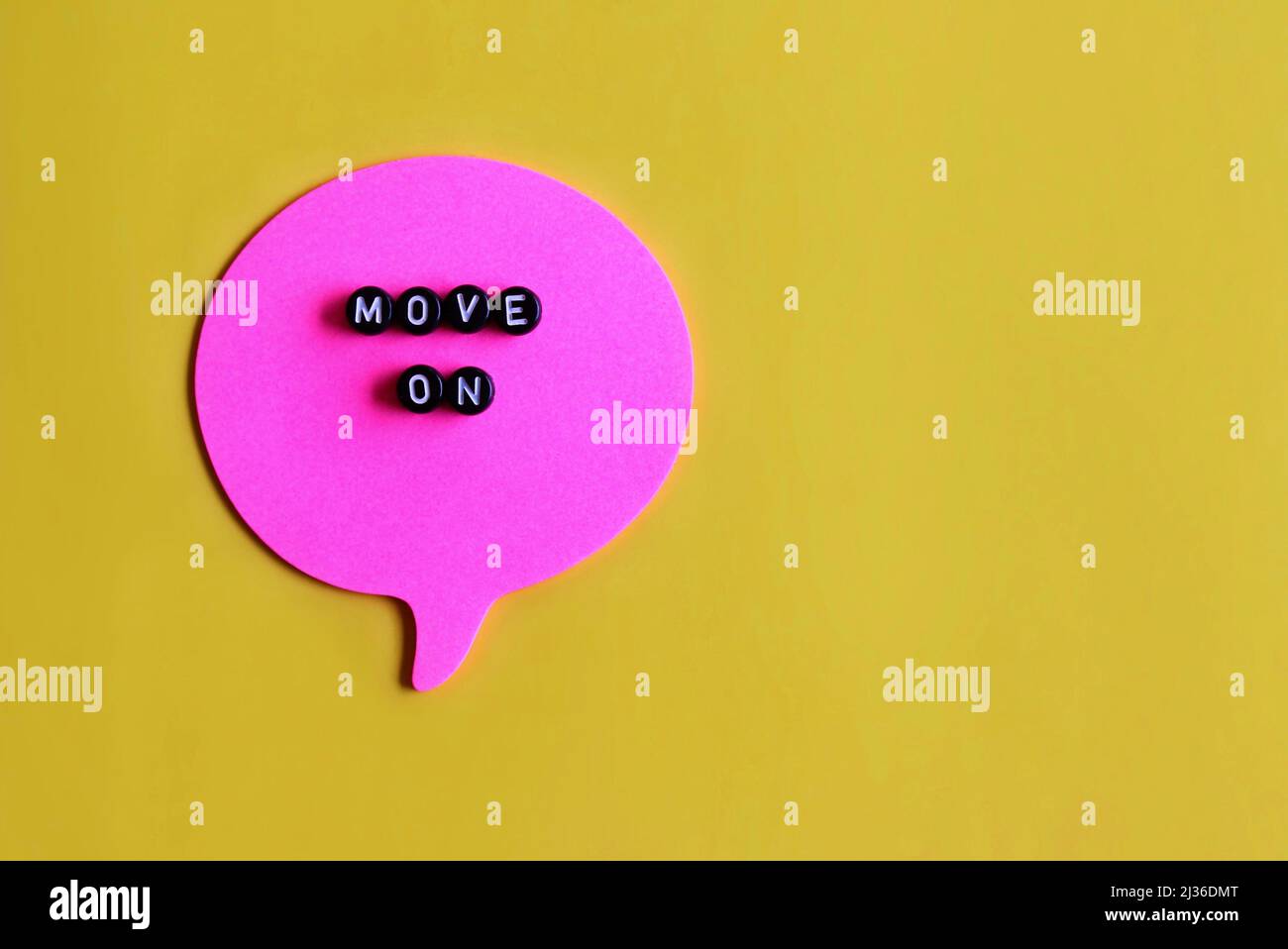 Top view image of alphabet cubes with text MOVE ON on speech bubble ...