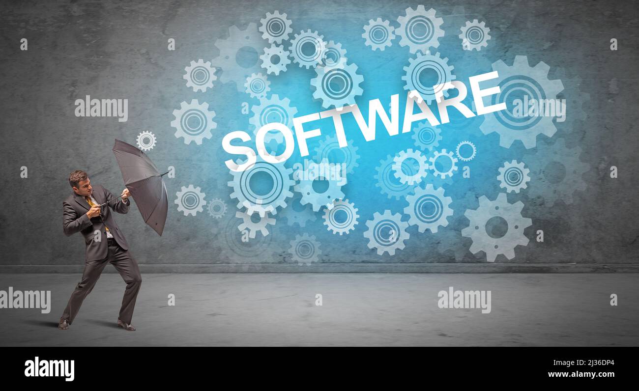 Businessman defending with umbrella concept Stock Photo - Alamy