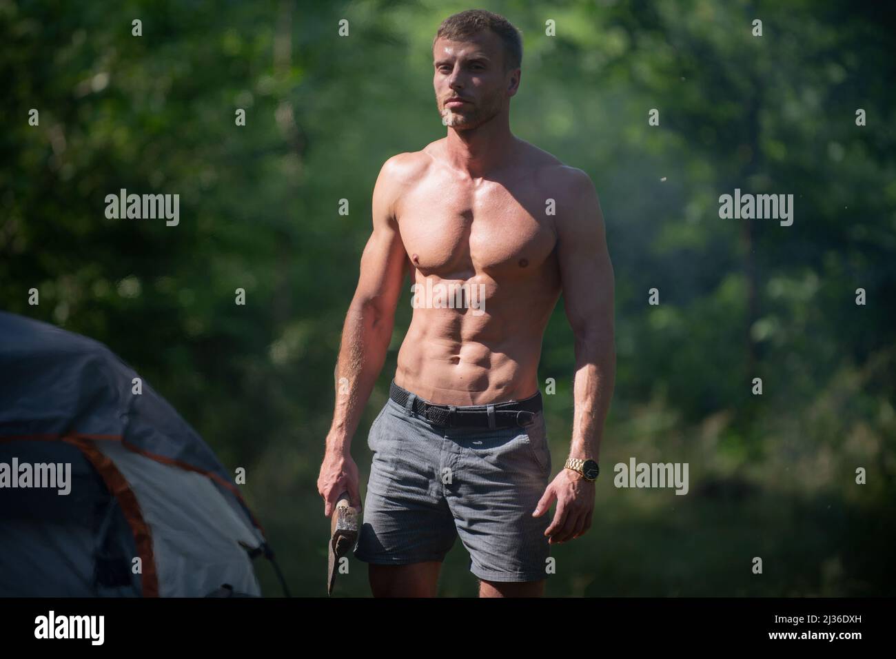 Handsome and muscular lumberjack man with an axe, camping Stock Photo ...