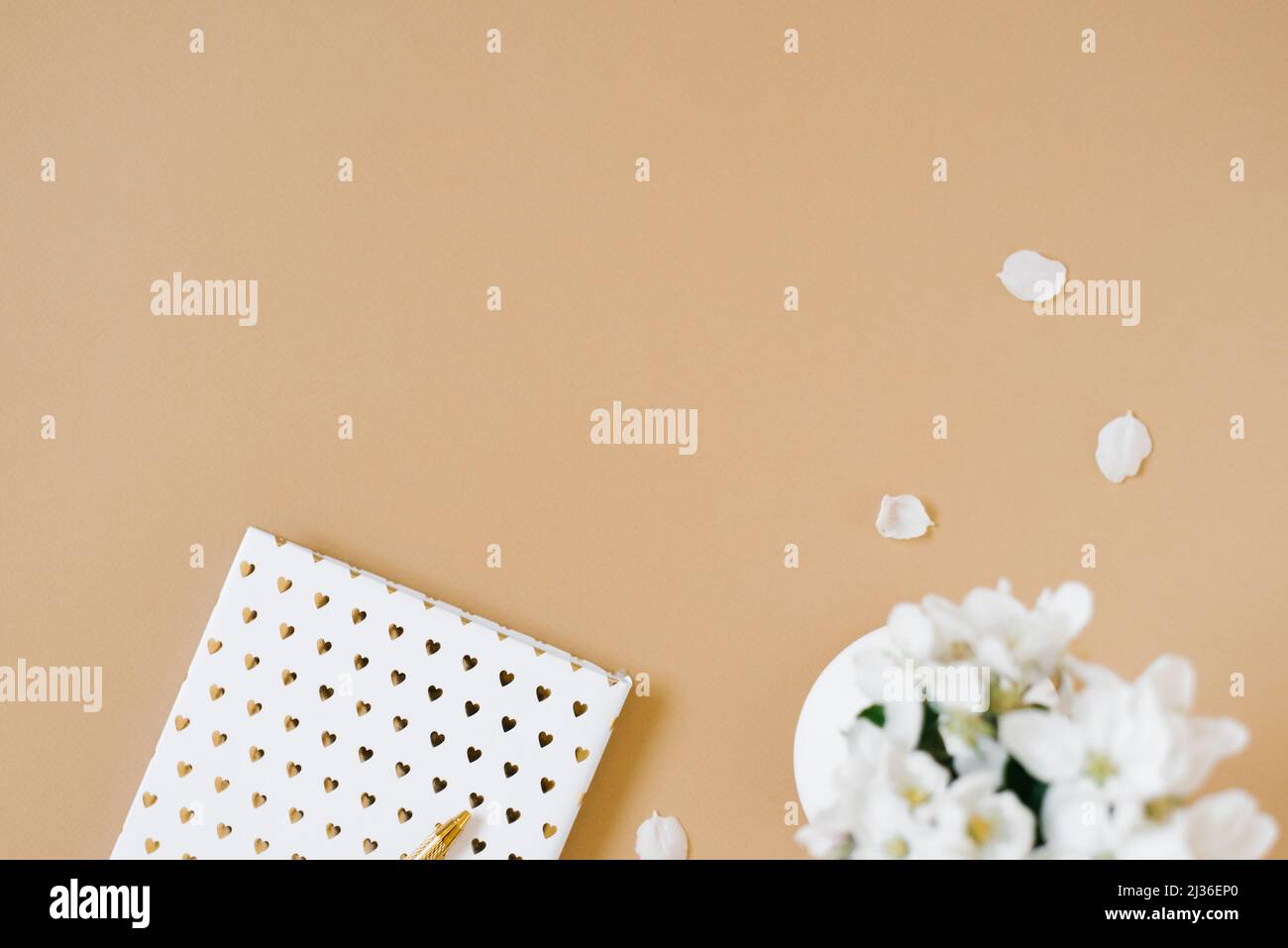 Work from home concept apartment lay on beige table with notepad, pen ...