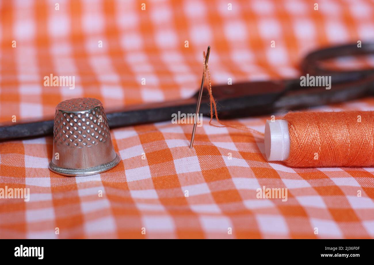 Orange and White Checkered Fabric With Thimble and Spool of Orange ...
