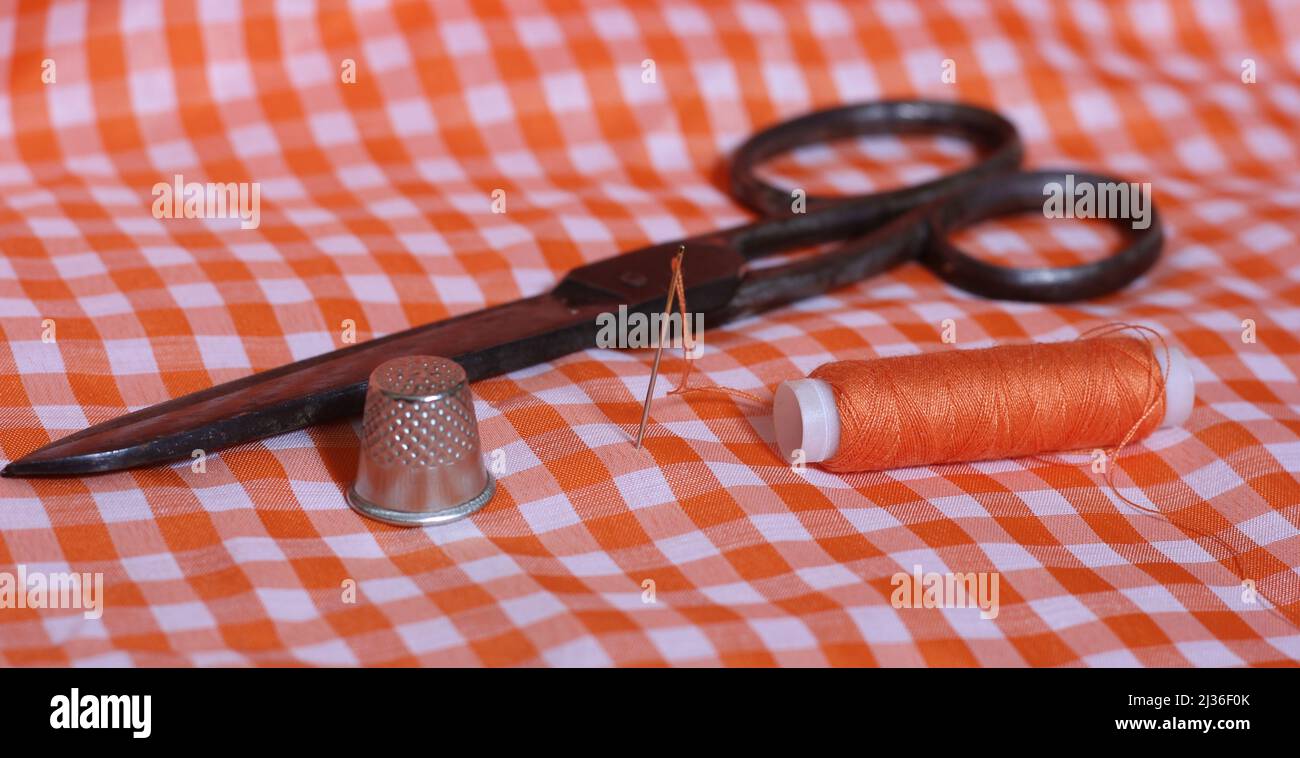 Orange and White Checkered Fabric With Thimble and Spool of Orange ...