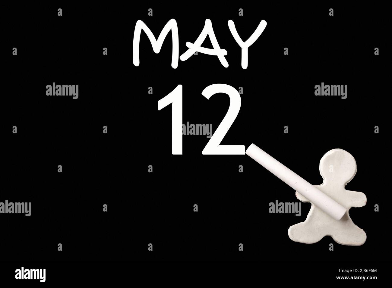 12th day of May. A small white plasticine man writing the date 12 May ...