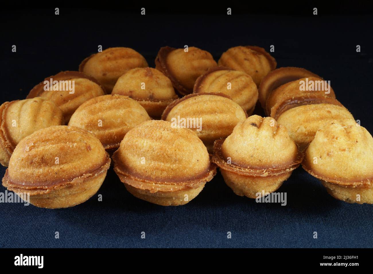 Pastry nuts with stuffing on the kitchen table, Food on a black ...