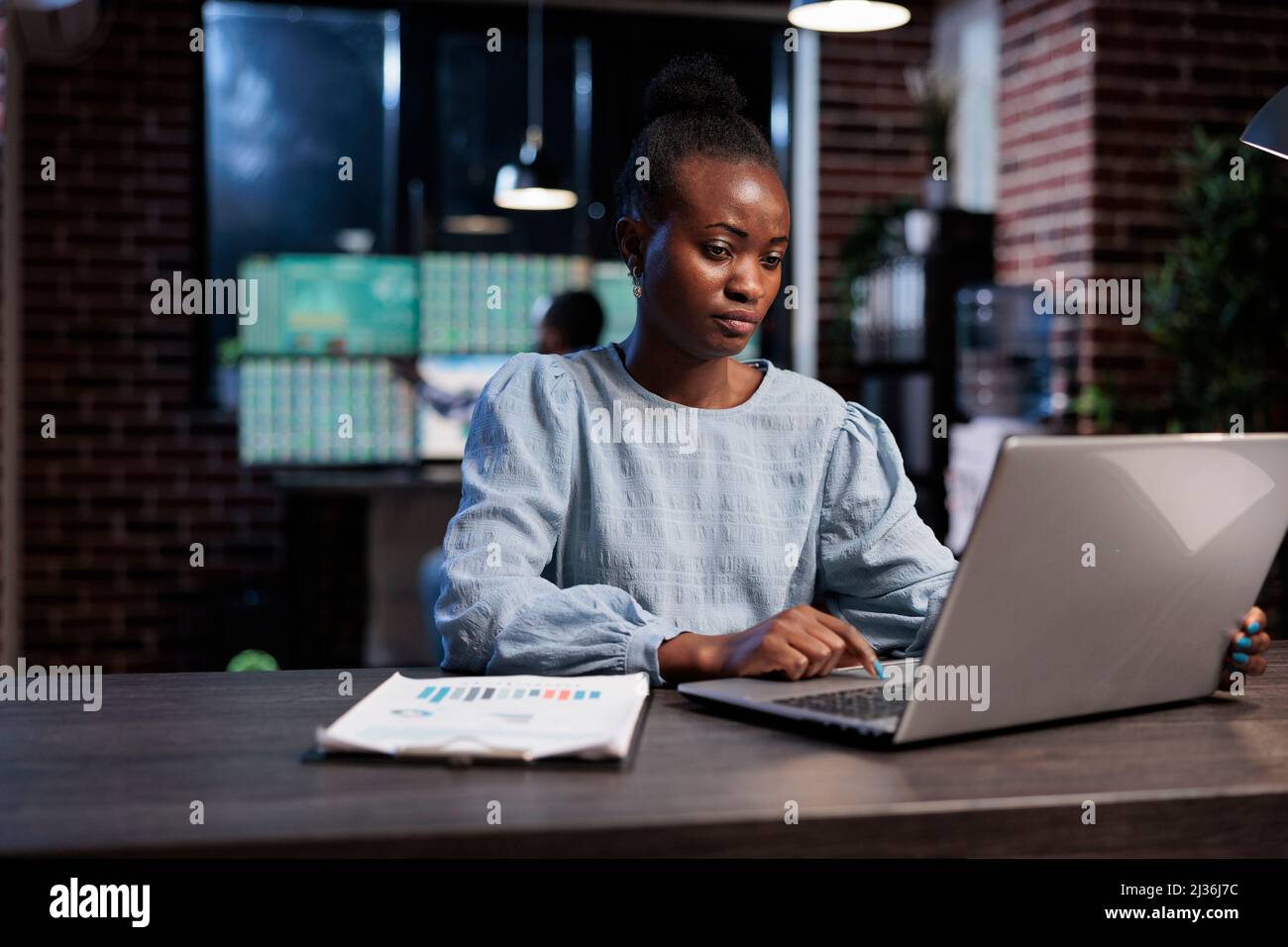 Forex stock market professional trader sitting at desk with laptop ...