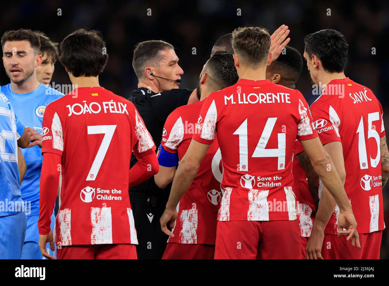 Athletico players surround the referee Stock Photo - Alamy