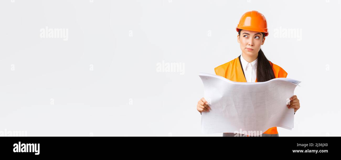 Thoughtful professional asian female construction manager, architect ...