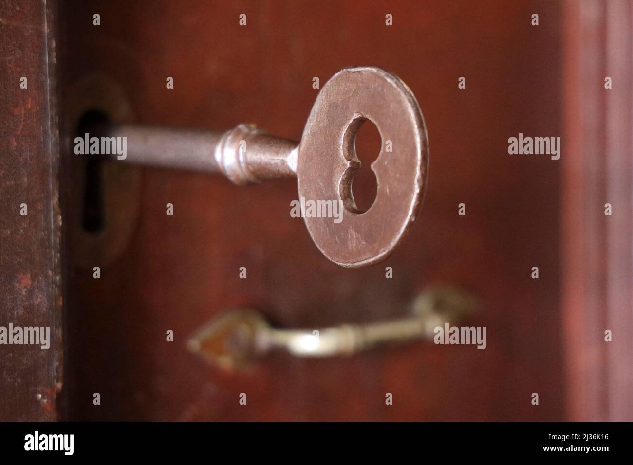 Close up of old handmade key in a lock at the Chidambara Vilas luxury ...