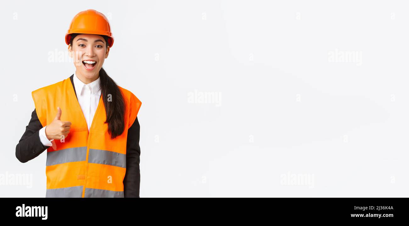 Supportive and pleased happy asian female chief engineer in safety ...