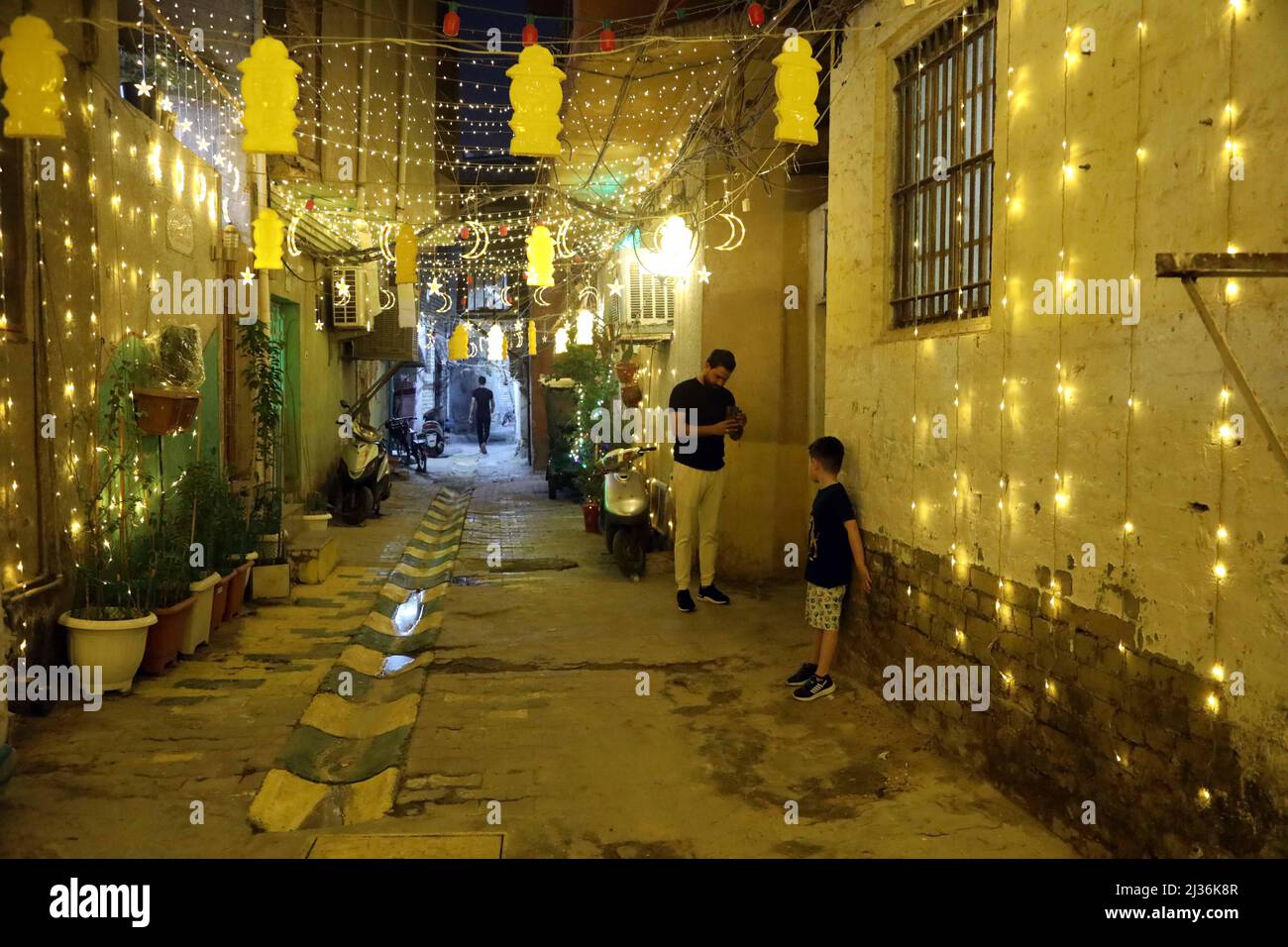 Baghdad, Iraq. 5th Apr, 2022. A man takes photos for his son in an ...