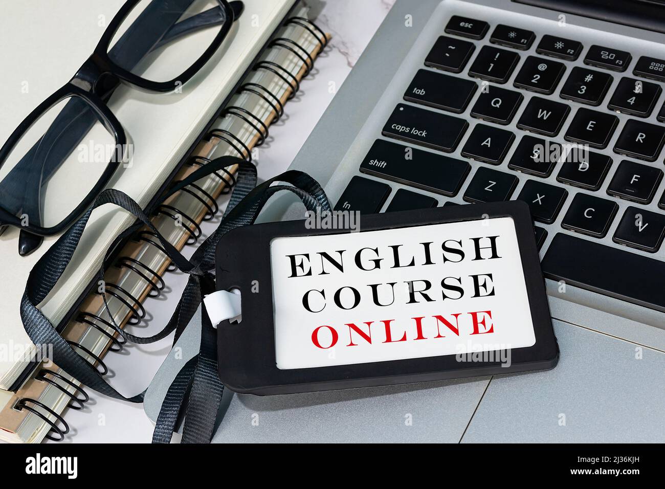 English course online text written on black name tag placed on a laptop ...