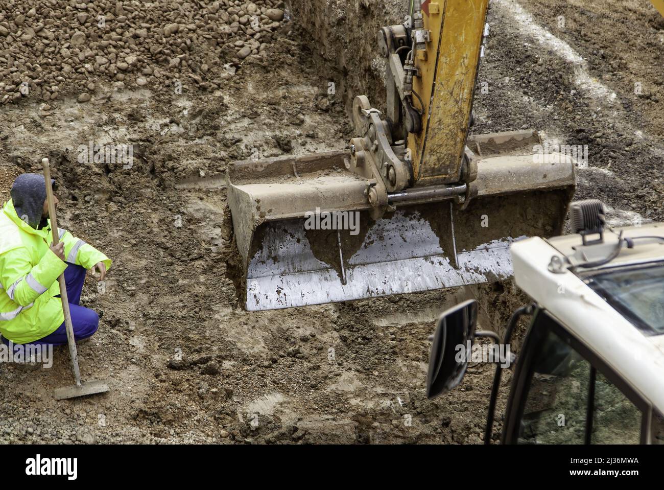 Detail of operators working in a public work, construction Stock Photo ...