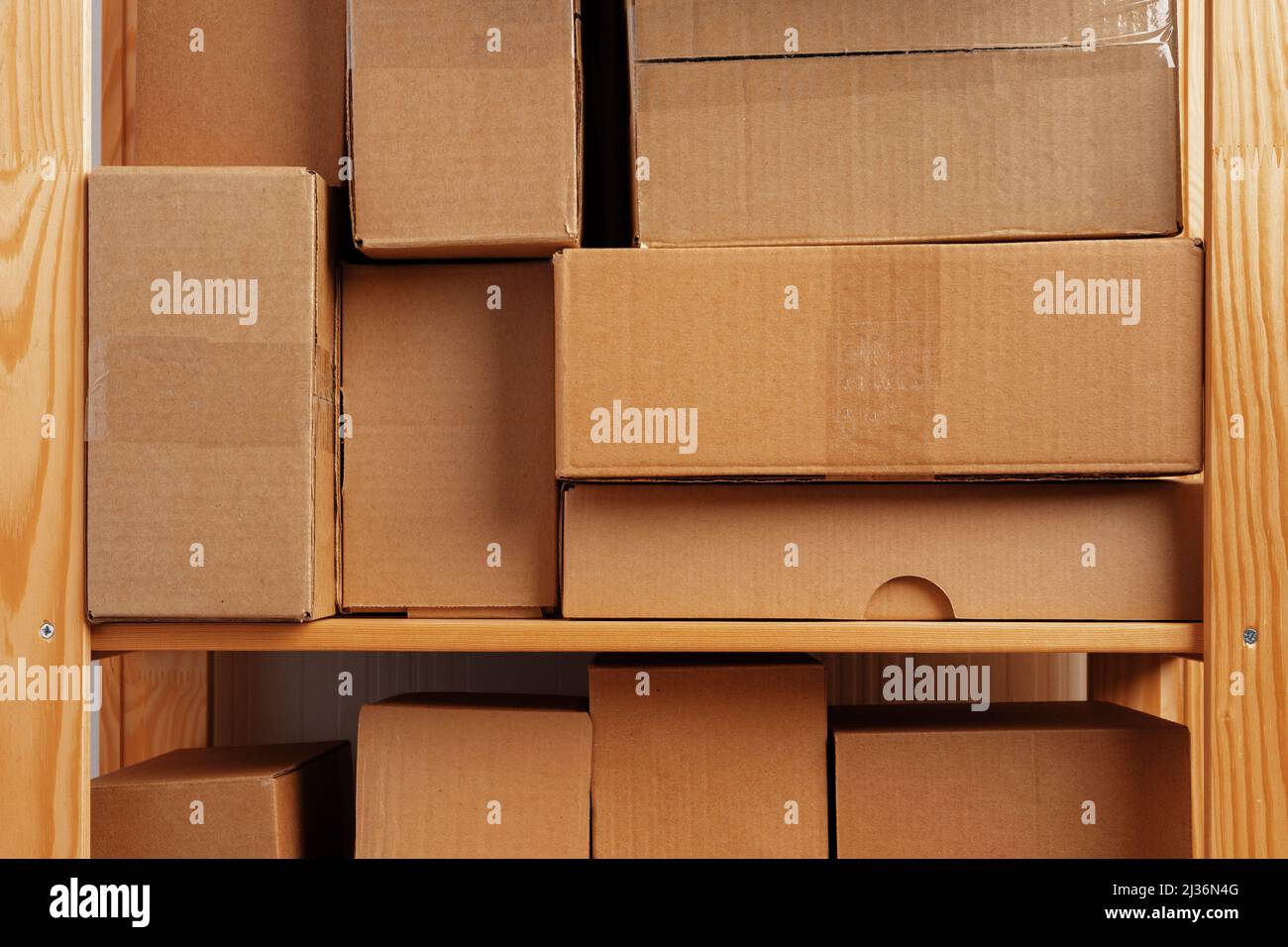 Stack of cardboard package boxes on wooden rack Stock Photo - Alamy