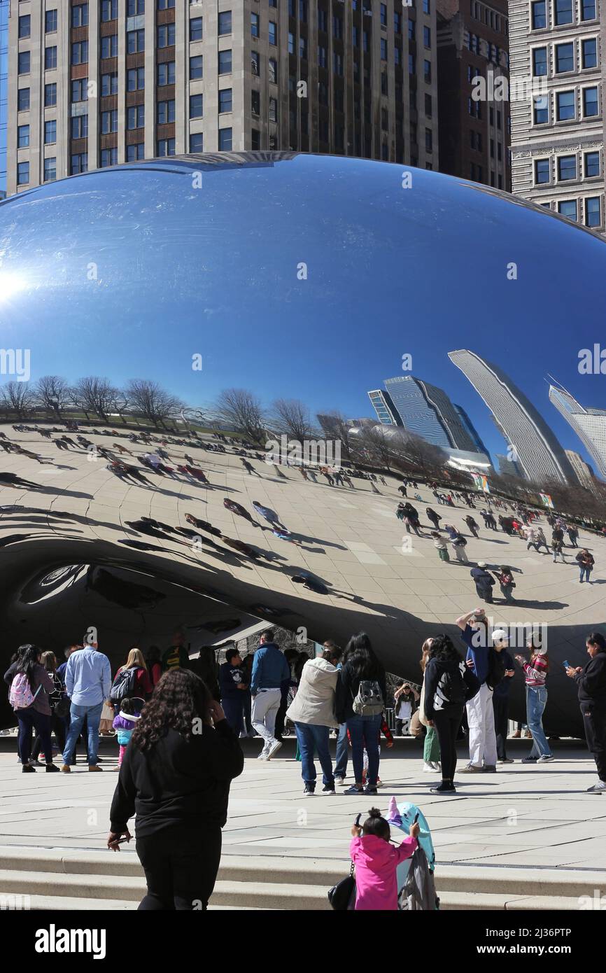 People standing around The Bean public art in downtown Millennium Park ...