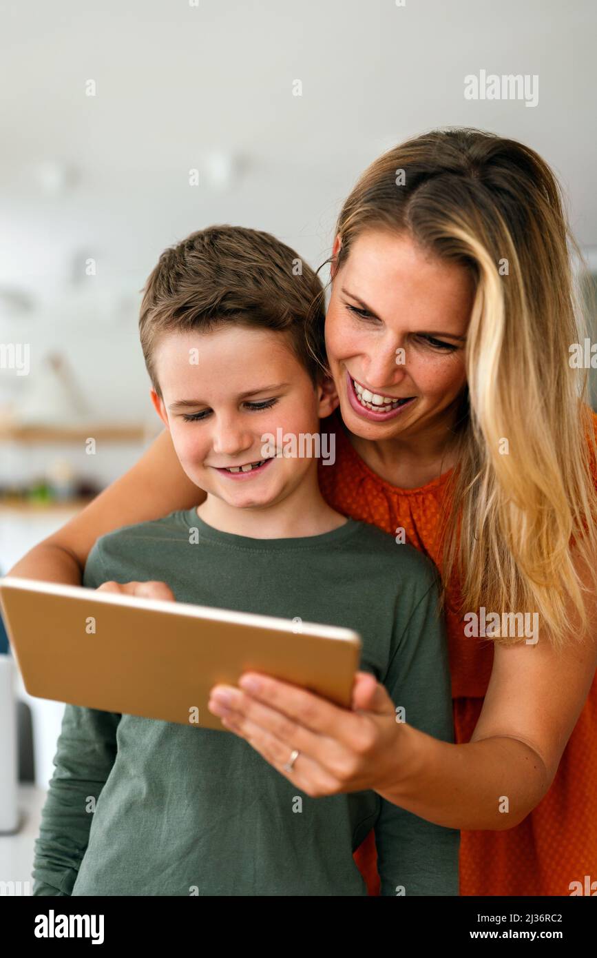 Mother and child using digital tablet for e-learning. Education home digital device kid concept ...