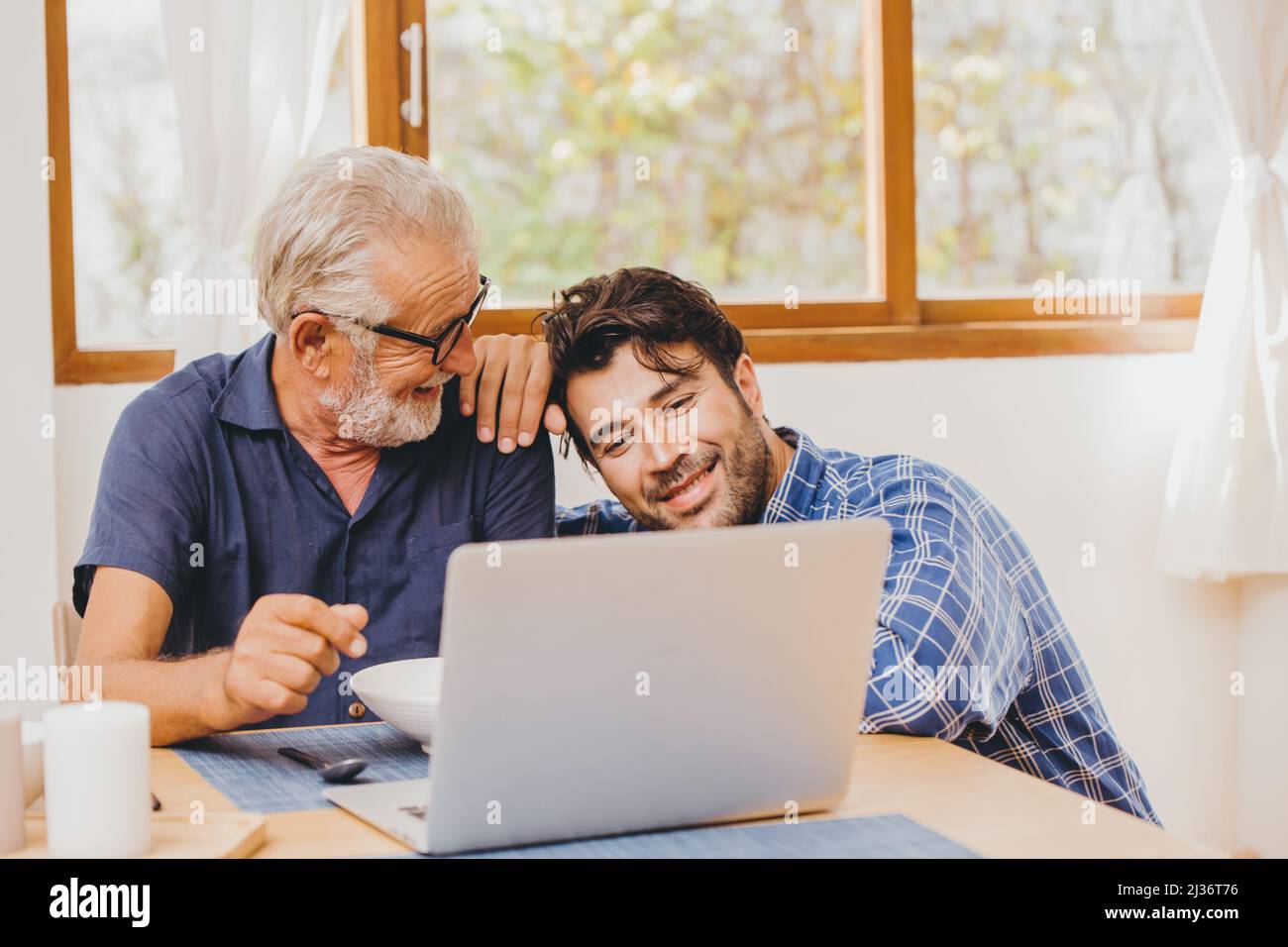 Son and Elder Father happy moment together looking at laptop for good memory Stock Photo - Alamy