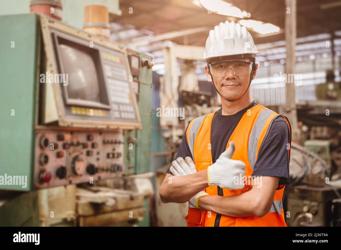 Confident Asian engineer worker man standing arm crossed happy smile ...