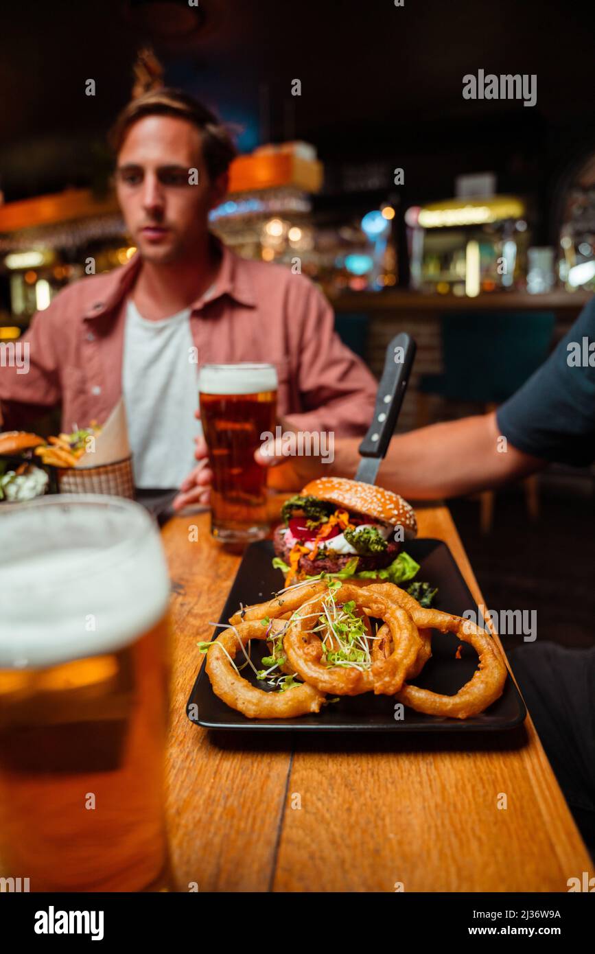 Man eating burger chips hi-res stock photography and images - Alamy