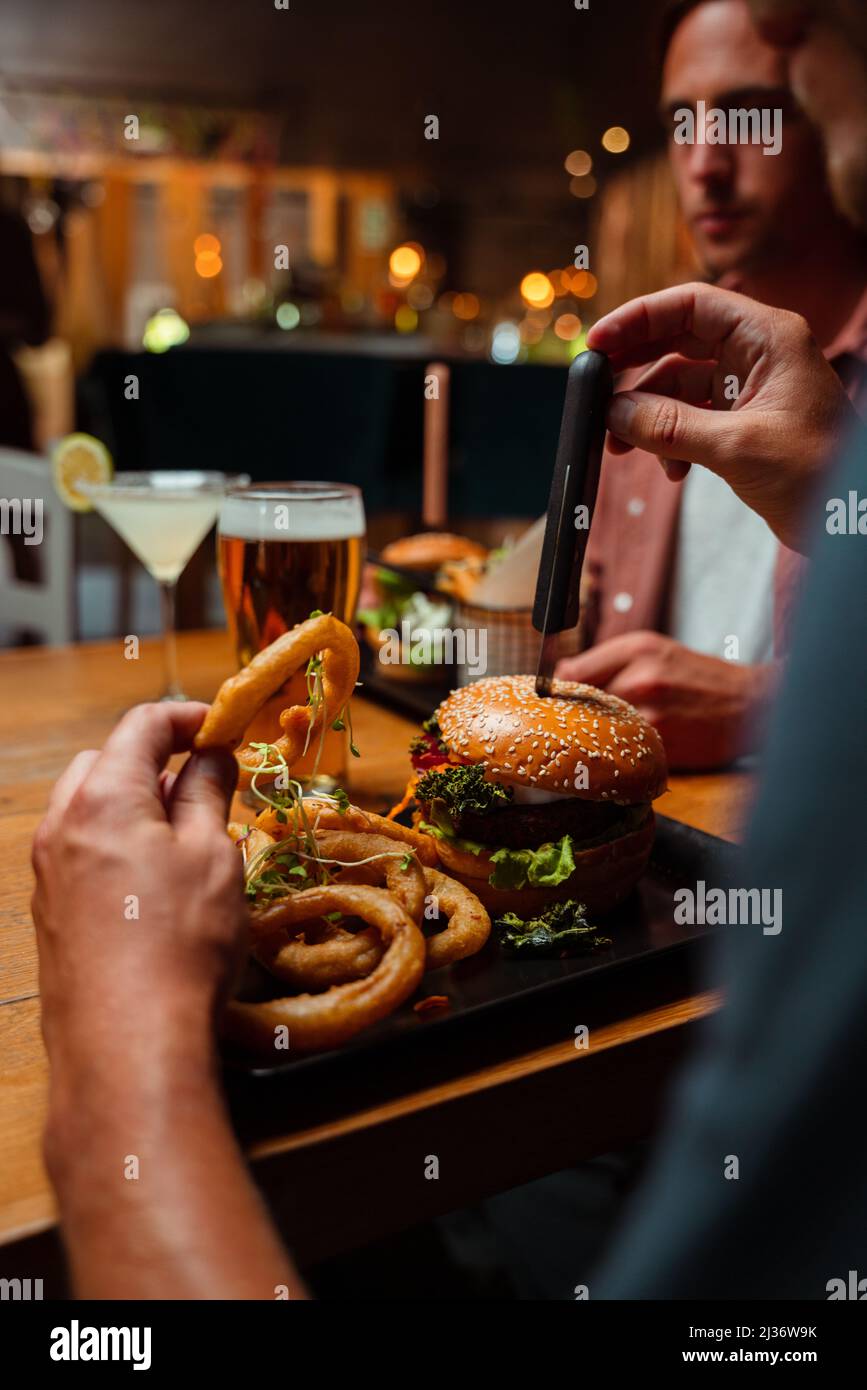 Man eating burger chips hi-res stock photography and images - Alamy