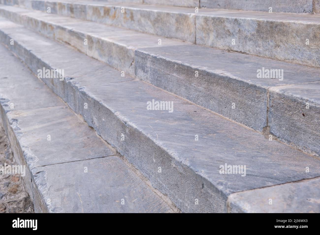 Old stone marble paved stair detail close up side view. Ermoupolis town ...