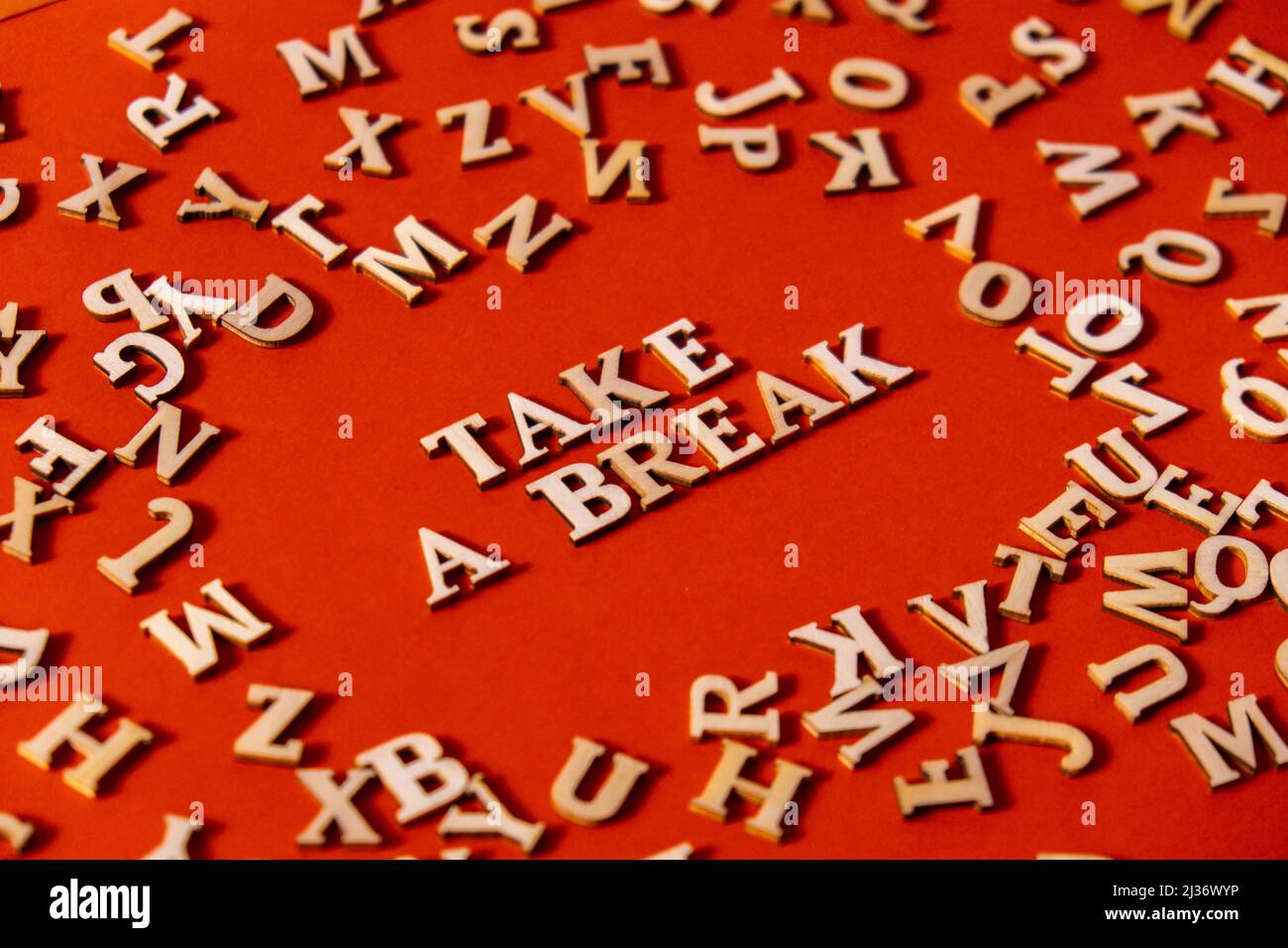 Quote TAKE A BREAK made out of wooden letters on bright red background ...