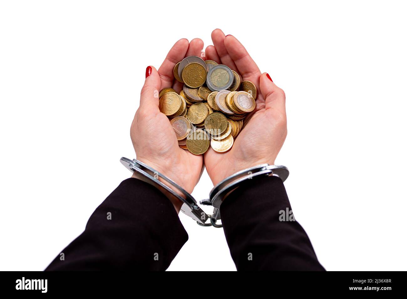 Women's handcuffed hands with a handful of euro coins, on a white ...