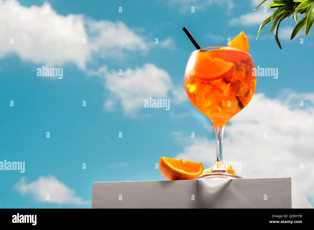 Glass of aperol spritz cocktail and blue sky background Stock Photo - Alamy