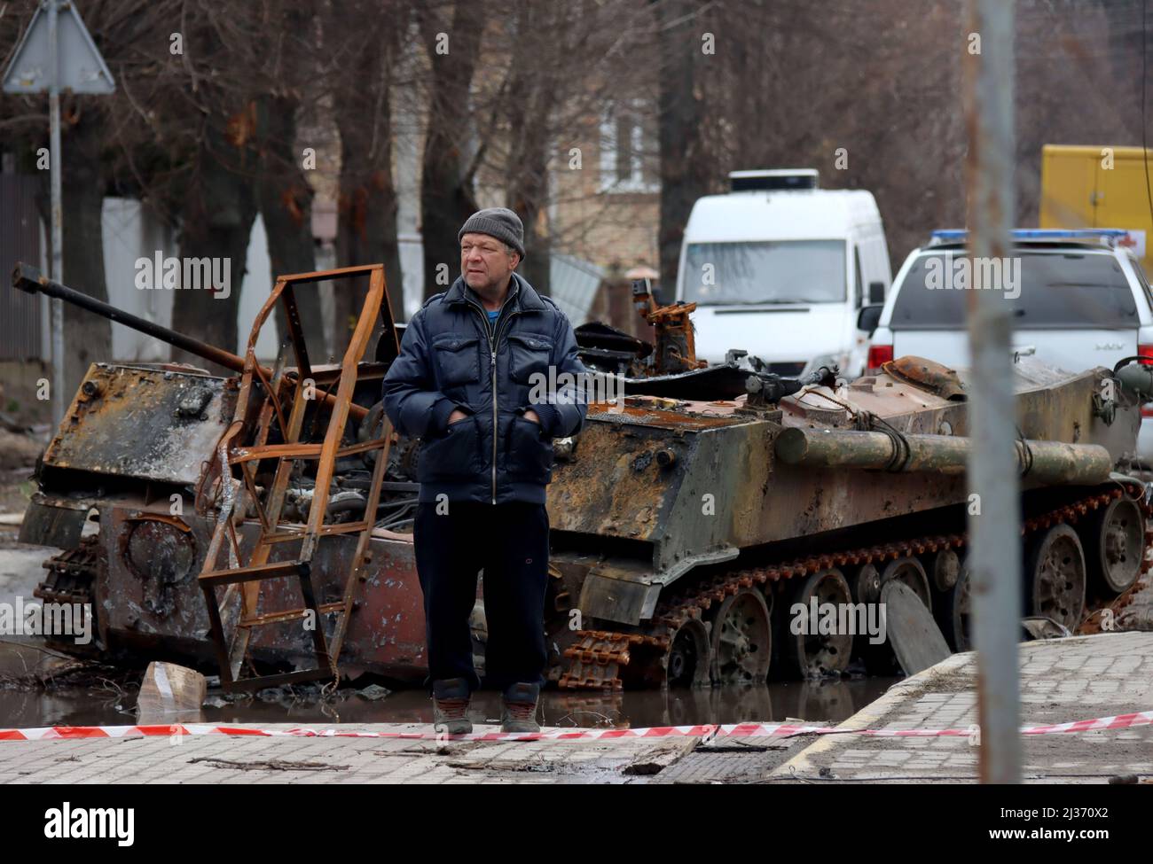 BUCHA, UKRAINE - APRIL 5, 2022 - A man stands in Vokzalna Street ...