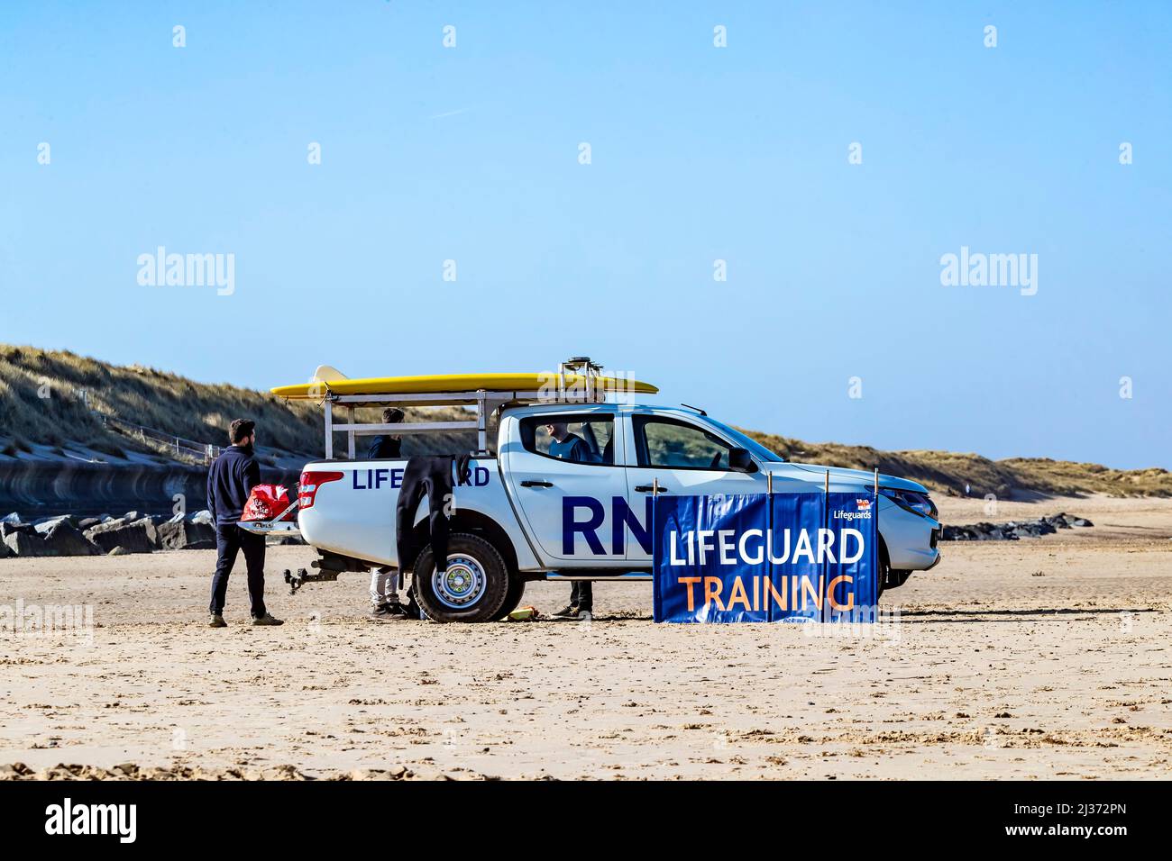 RNL Lifeguard training on the beach at Sea Palling on a bright sunny ...