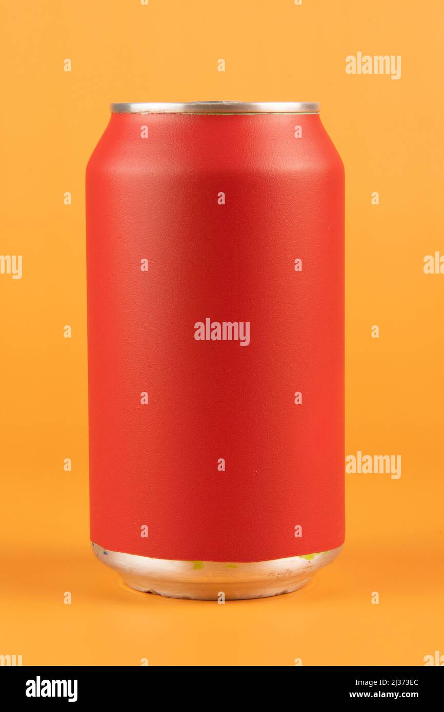 red aluminum can isolated on orange background Stock Photo - Alamy