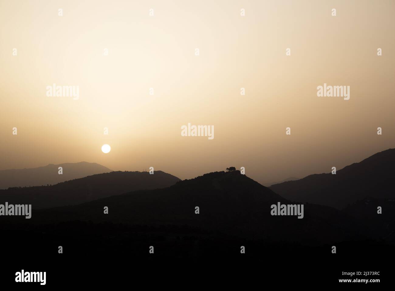 Sunset in the mountains with the sun. No people Stock Photo - Alamy