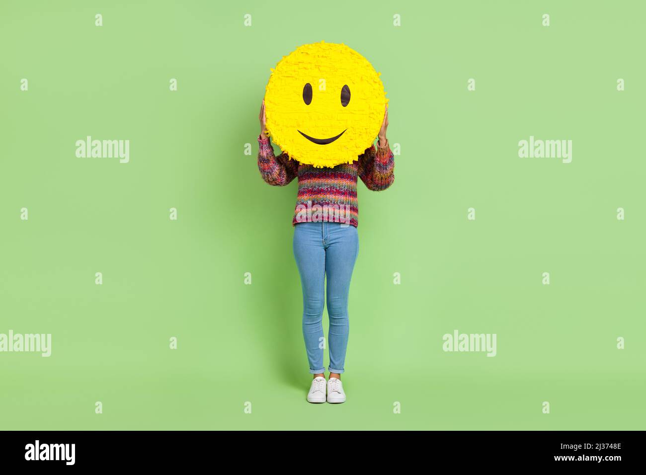 Photo of cute shiny lady dressed knitted pullover holding smiley cover ...