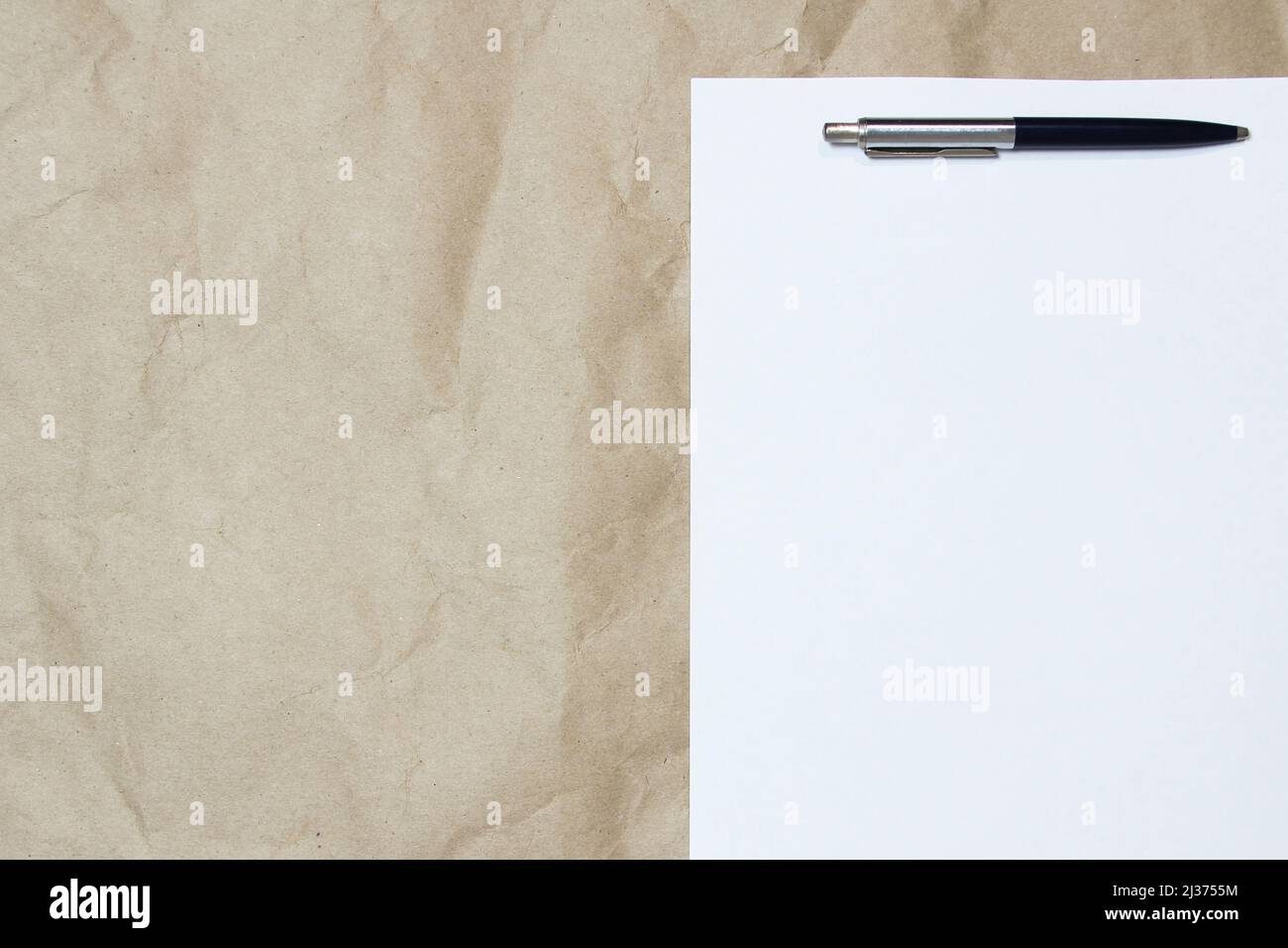 White empty sheet of A4 format with pen on a beige craft paper. Concept ...