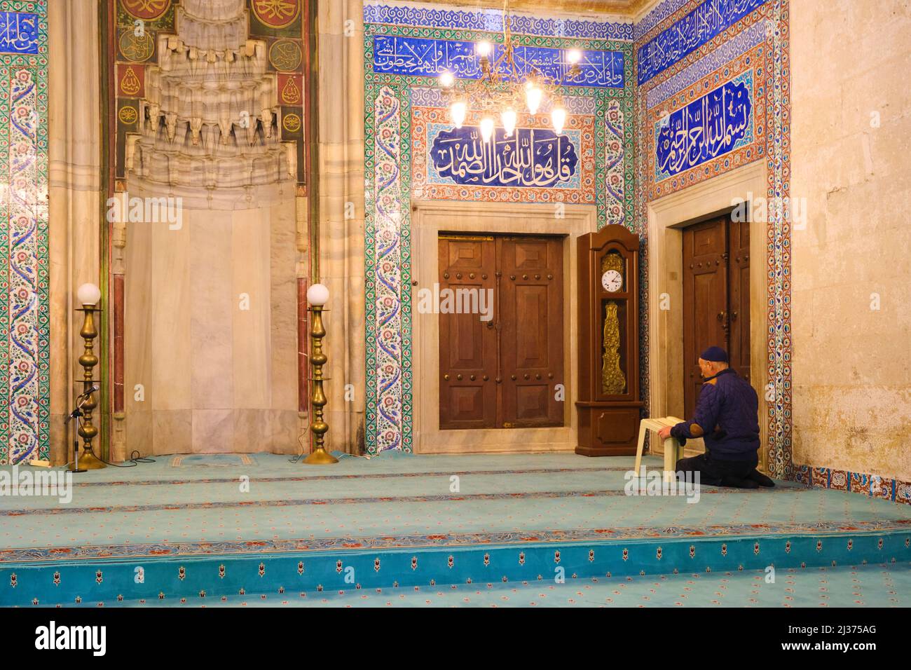 An interior view of the mosque with one man praying, including the ...