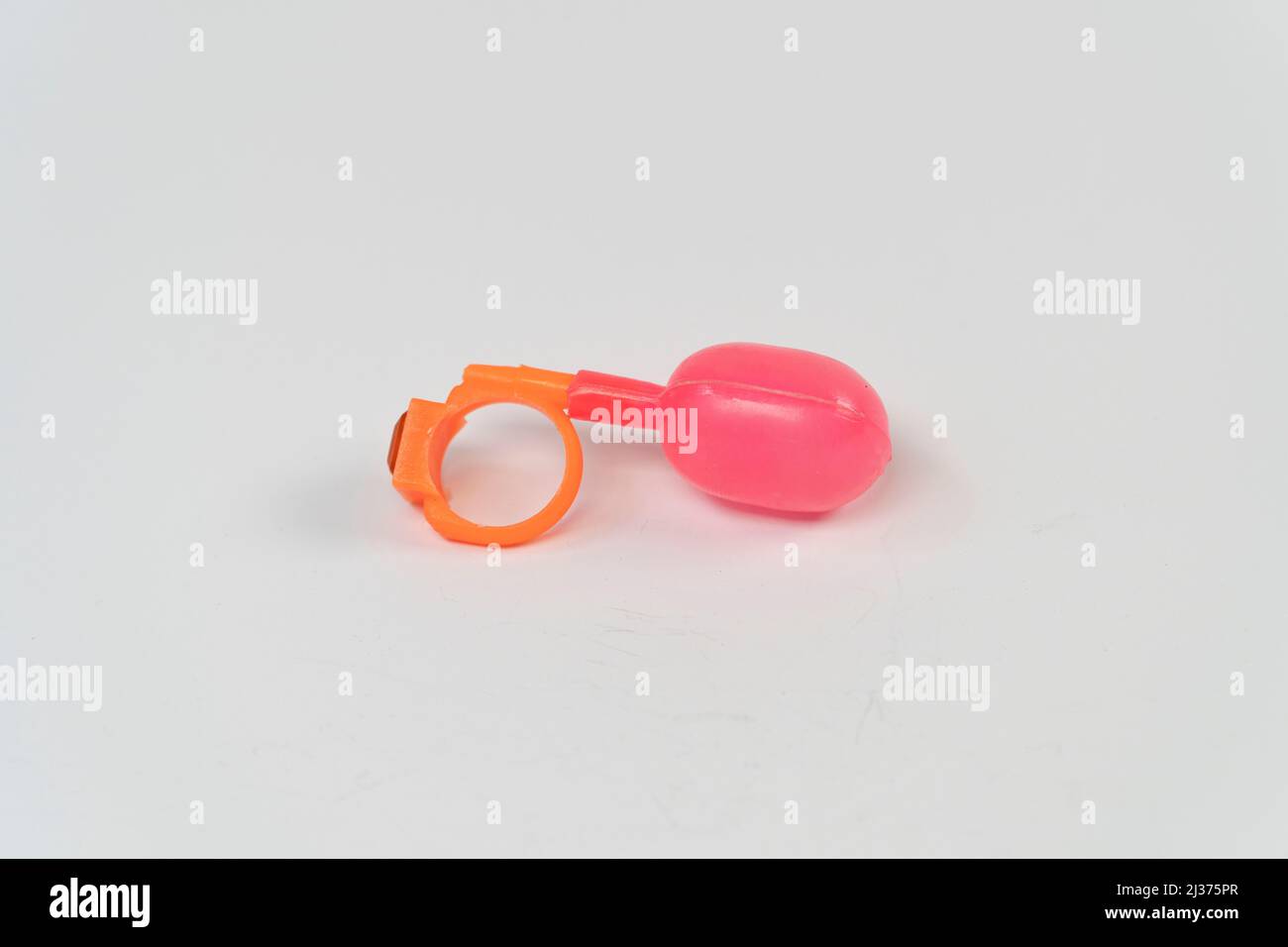Joke ring toy isolated on white background, water squirting fake ring ...