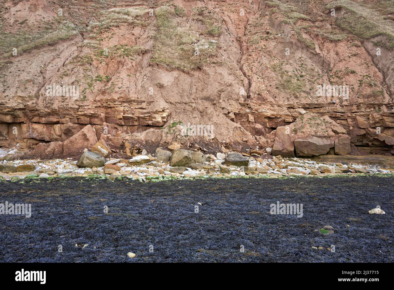 Small rock fall at the bottom of a cliff Stock Photo - Alamy