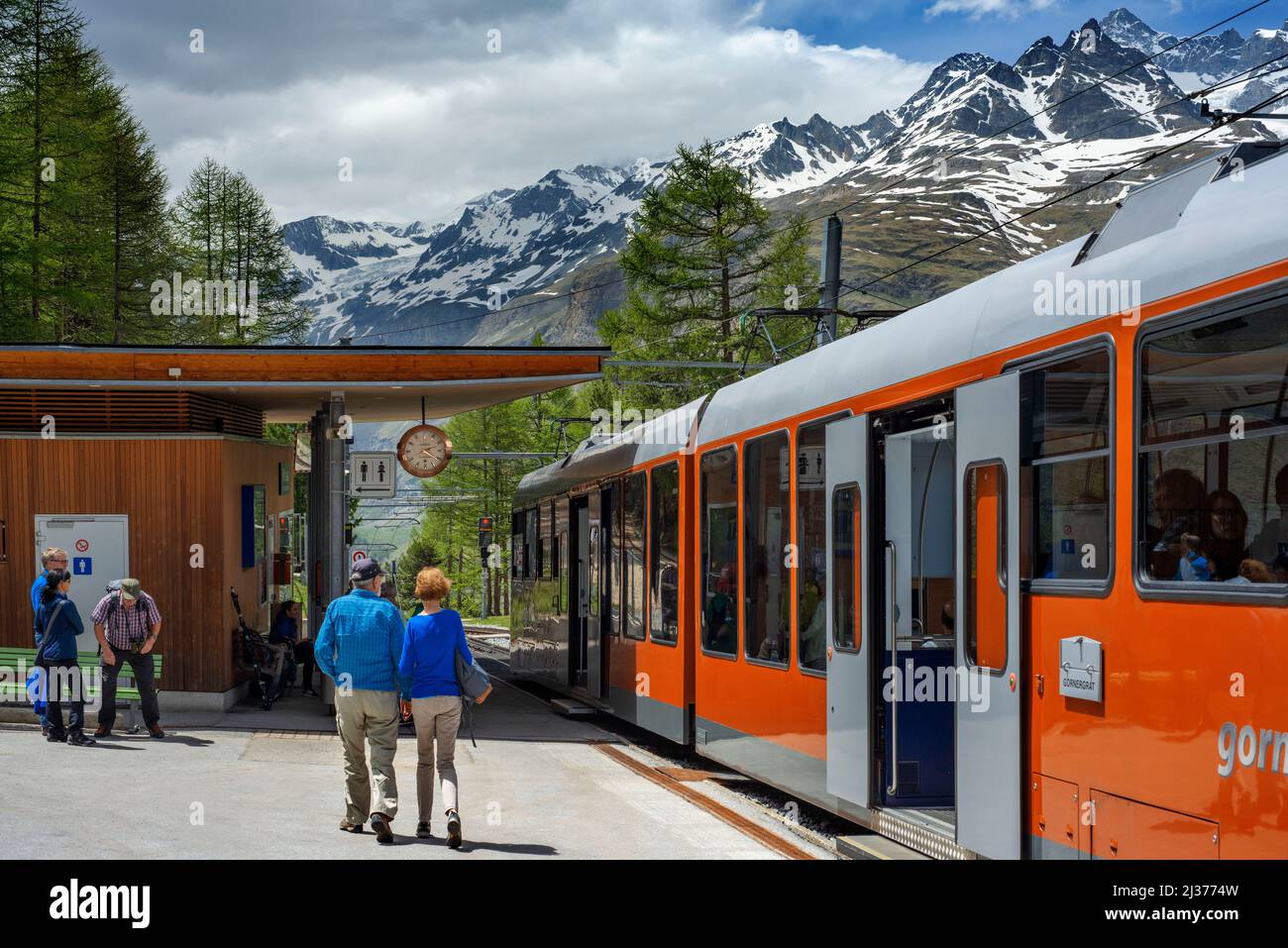 A train from Zermatt stoped at Riffelalp Station facing the majestic ...