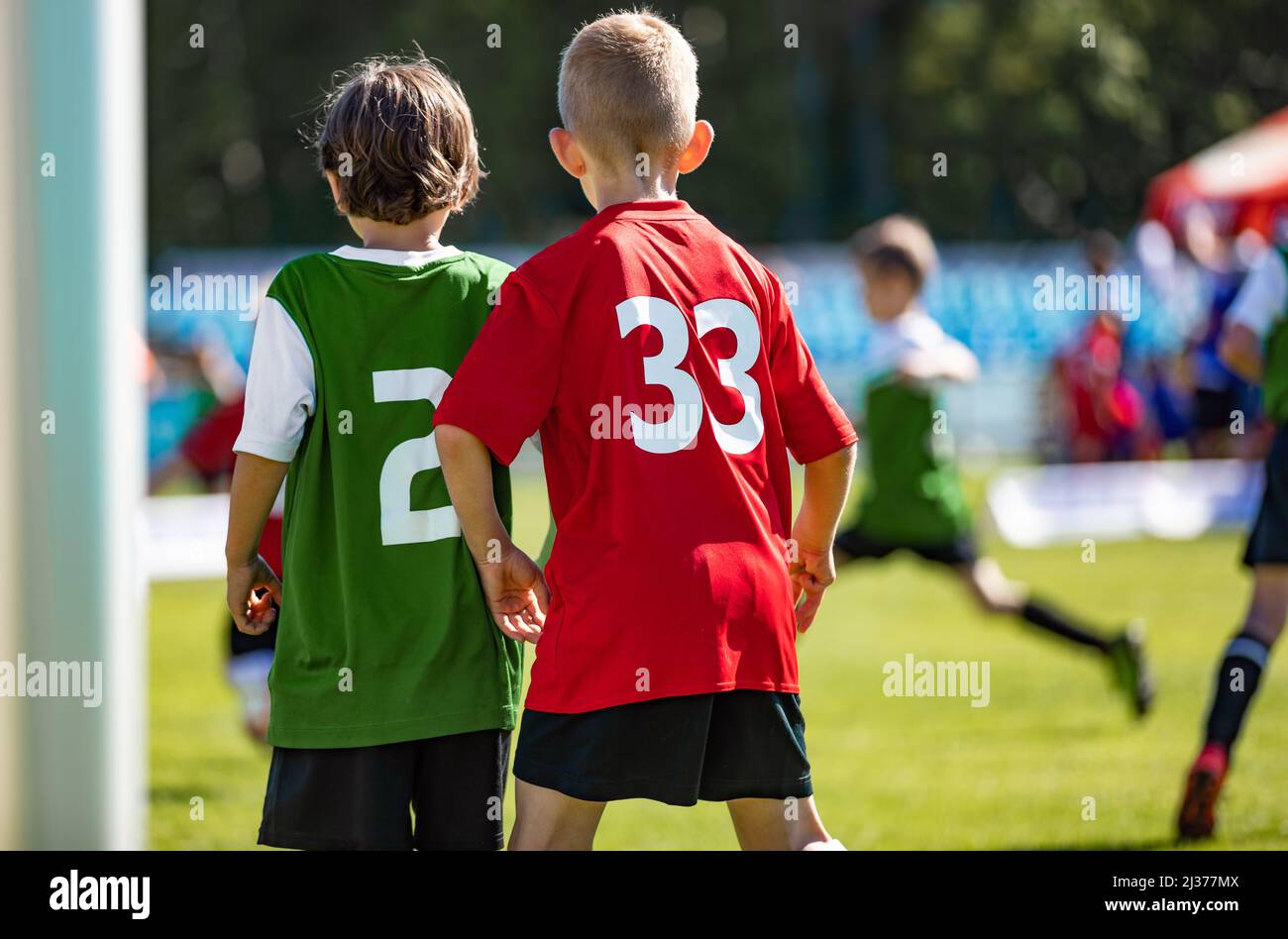 Two Young Boys Comptete in Sports Game. Kids in Opposite Team Standing ...