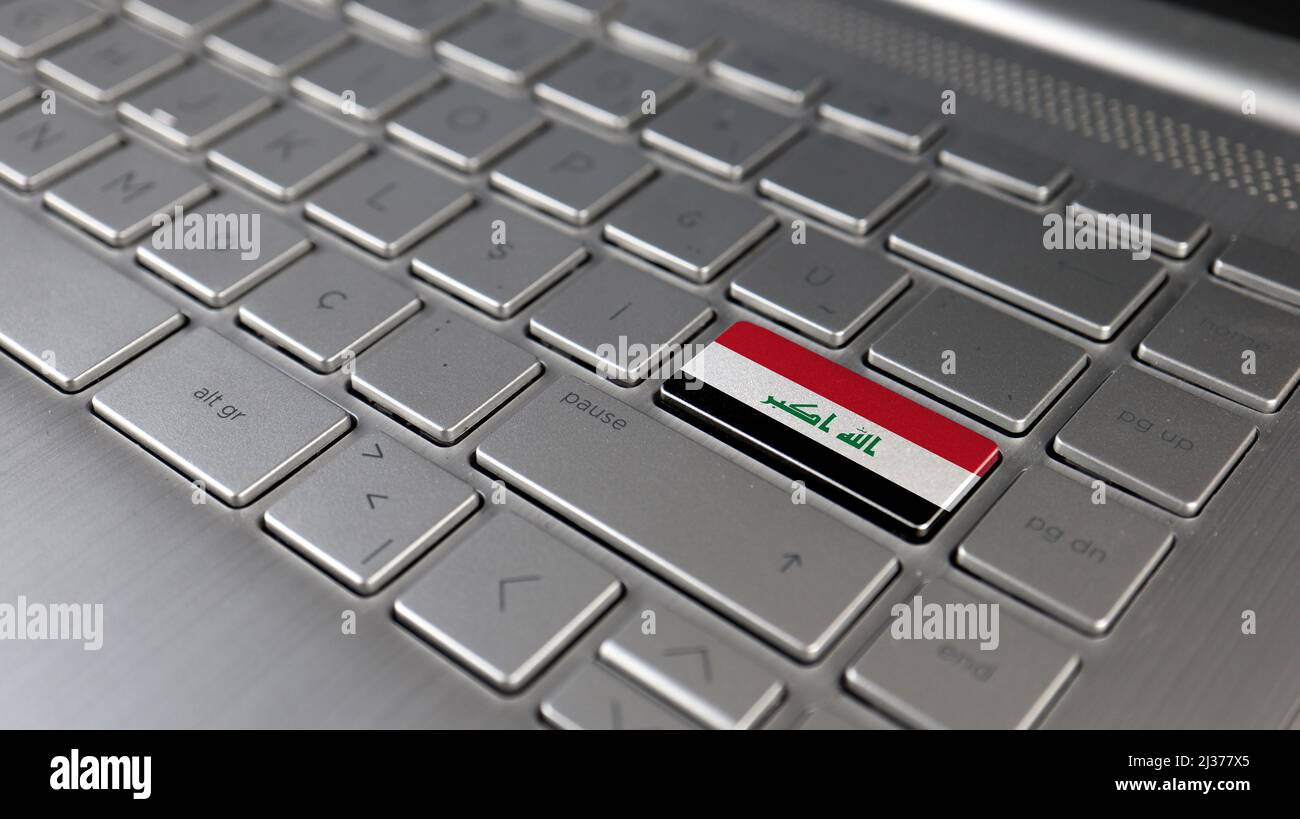Keyboard with Iraq flag on the enter button, represents cyber attack of ...