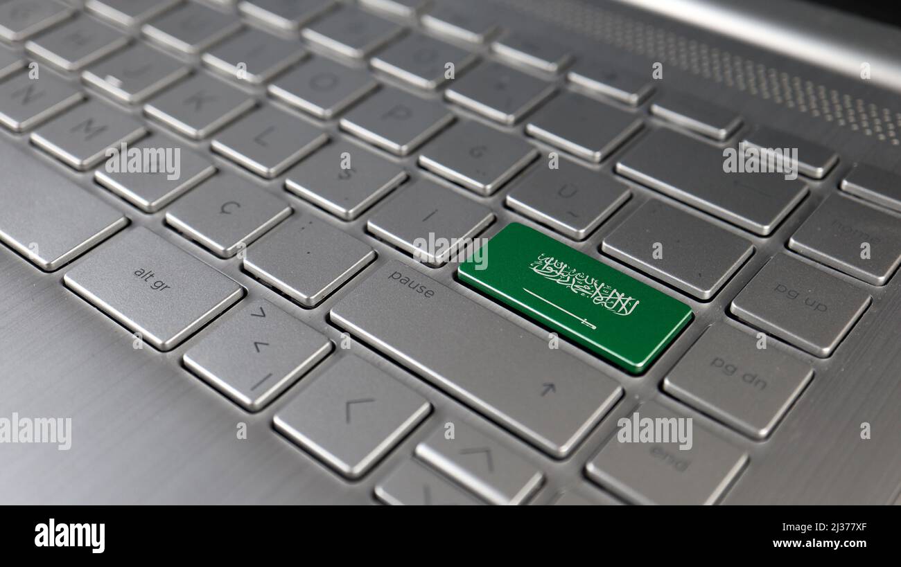 Keyboard with Saudi Arabia flag on the enter button, represents cyber ...