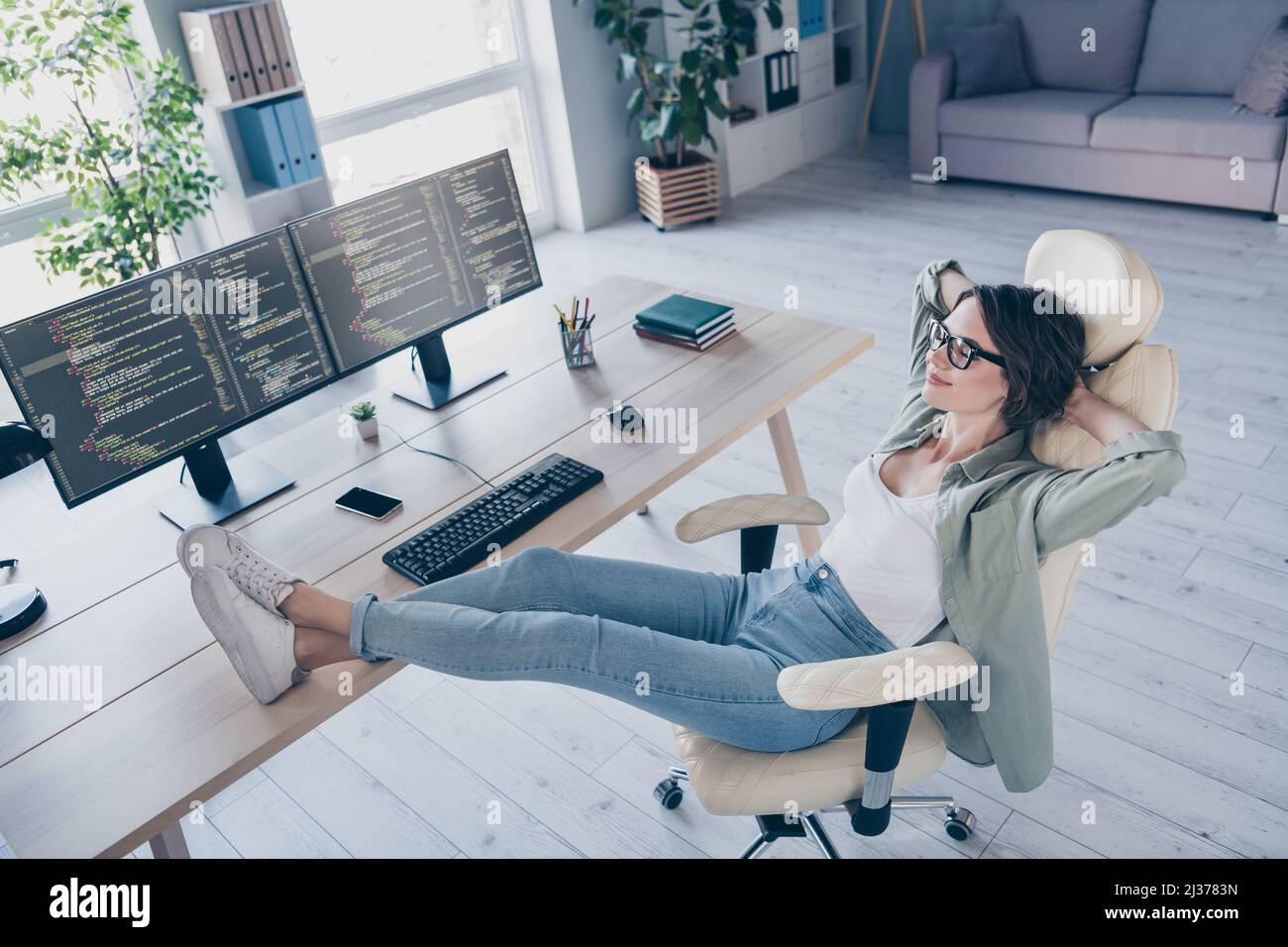 Full size portrait of happy lady sit chair hands behind head legs on ...