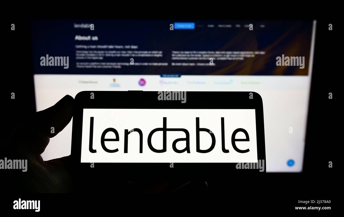 Person holding mobile phone with logo of British fintech company ...