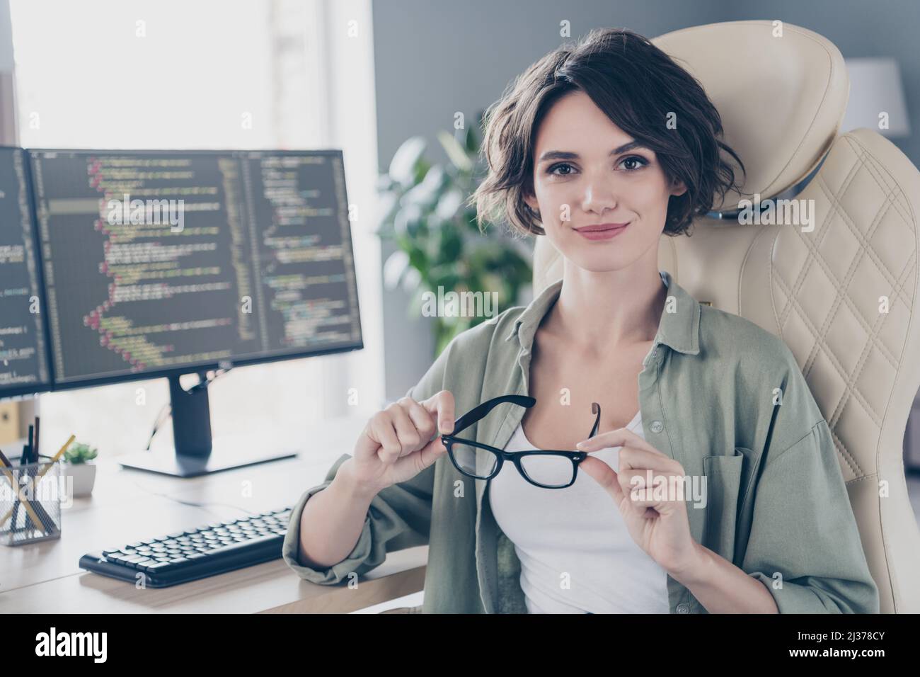 Photo of smart experienced person sit chair hold spectacles look camera ...