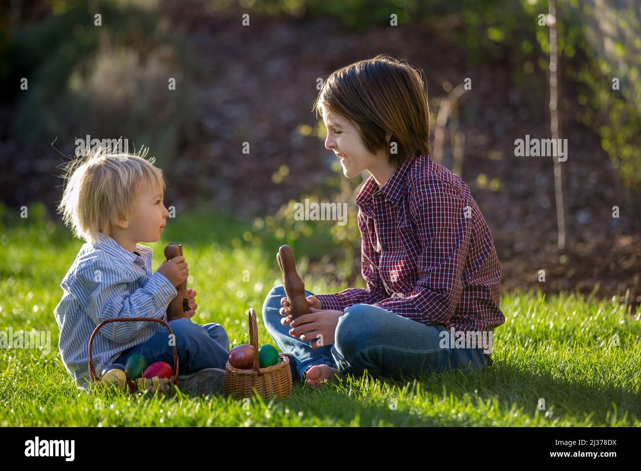 Cute children, eating chocolate bunnies and fighting with easter eggs ...