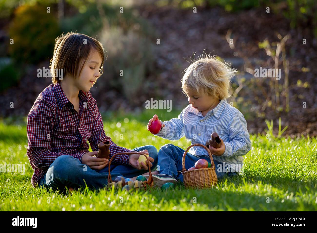 Cute children, eating chocolate bunnies and fighting with easter eggs ...