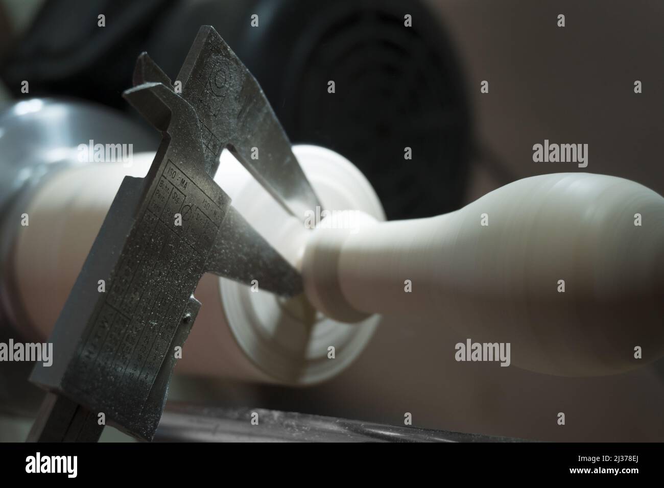 Close-up of measuring the thickness of a wooden workpiece during ...